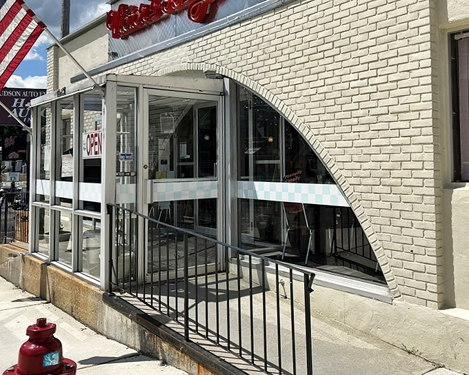 The neon glow of Victor's 50's Diner sign beckons like a time machine disguised as a restaurant. Hudson's retro gem promises comfort food that'll make your cardiologist wince and your soul sing.