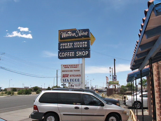 The neon-adorned vintage sign stands like a sentinel of comfort food, promising steaks, seafood, and the timeless appeal of a genuine coffee shop experience.