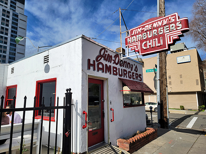 The little diner that could! Jim Denny's stands proudly amid Sacramento's skyline, its vintage red-and-white charm a defiant throwback to simpler times.