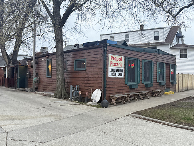 The unassuming wooden exterior of Pequod's hides pizza greatness like Clark Kent's glasses hide Superman. This humble facade in Morton Grove has become a pilgrimage site.