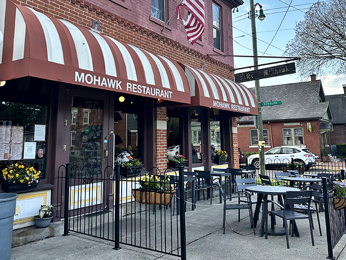 The iconic red brick and striped awning of The Old Mohawk stands as a beacon of comfort in Columbus' German Village. A neighborhood landmark that promises good times inside.