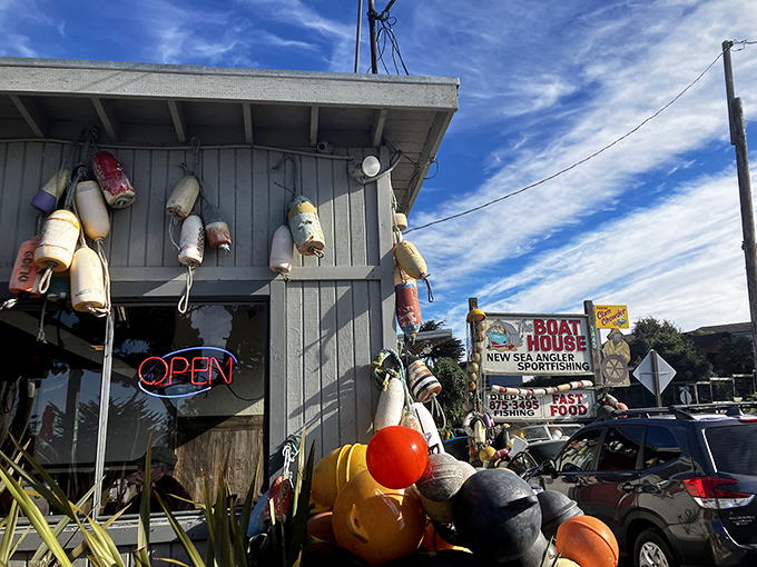 Maritime charm meets culinary treasure at The Boat House's exterior, where colorful buoys and fishing floats hint at the ocean-fresh delights waiting inside.