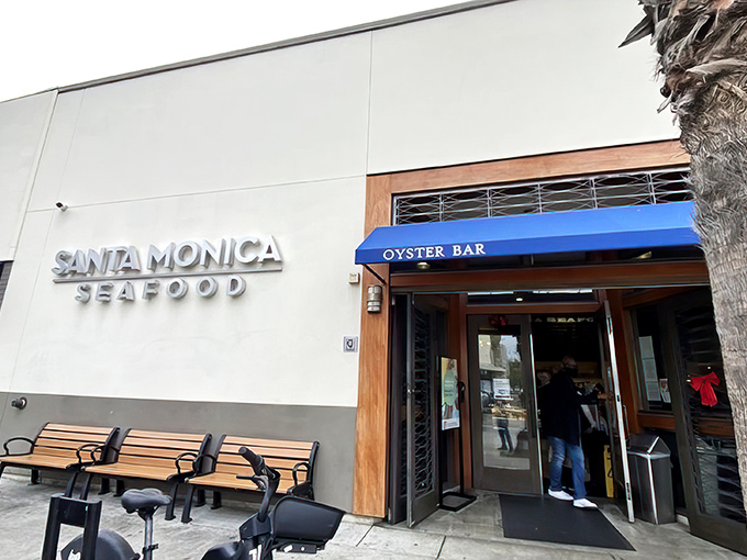 The iconic blue awning of Santa Monica Seafood beckons seafood lovers like a maritime lighthouse guiding hungry sailors to shore.