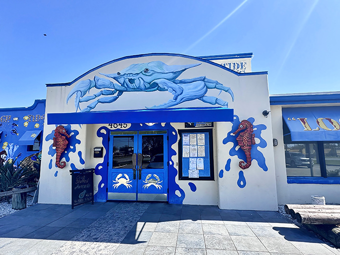 A seafood siren song in blue and white, High Tide Harry's exterior promises oceanic delights with its giant crab sculpture and splashy nautical theme.