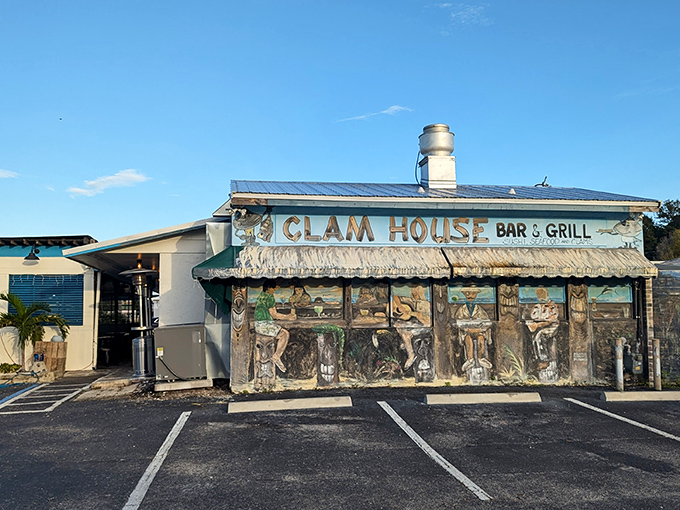 The unassuming blue-roofed exterior of The Clam House stands like a seafood speakeasy, promising treasures within that no fancy facade could improve upon.