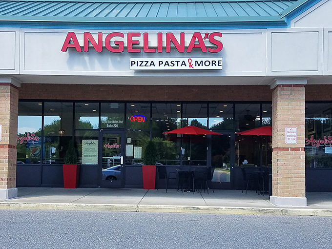 The bright red signage beckons like a lighthouse for the pasta-starved. Come for the promise of "Pizza Pasta & More," stay for the red umbrella charm.