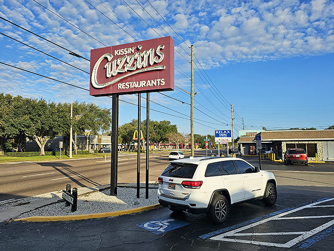 The iconic Kissin' Cuzzins sign stands tall against Florida's perfect blue sky, beckoning hungry travelers with promises of breakfast bliss.