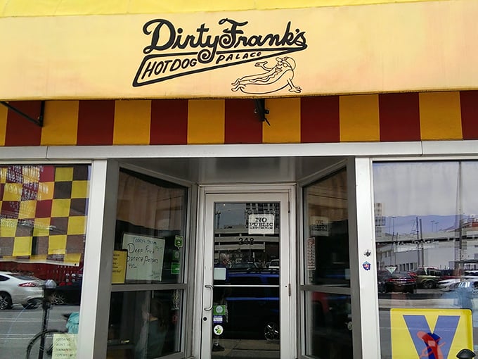 The cheerful red and yellow awning of Dirty Frank's beckons like a hot dog lighthouse, guiding hungry souls to wiener paradise since 2009.