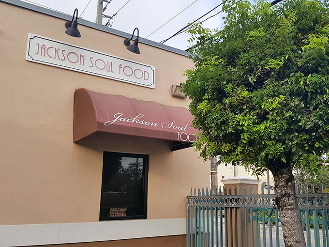 The unassuming peach-colored exterior with its burgundy awning is Miami's soul food beacon &ndash; no flash, just pure culinary promise waiting inside.