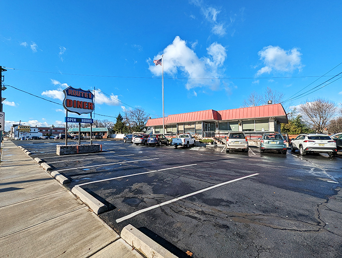 The classic red roof of Route 1 Diner stands like a beacon for hungry travelers, complete with American flag proudly waving &ndash; a true Jersey roadside landmark.