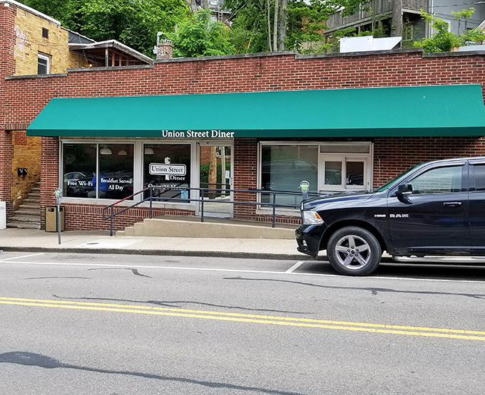 The unassuming brick exterior with its signature green awning promises comfort food magic within. Athens' hidden breakfast gem awaits.