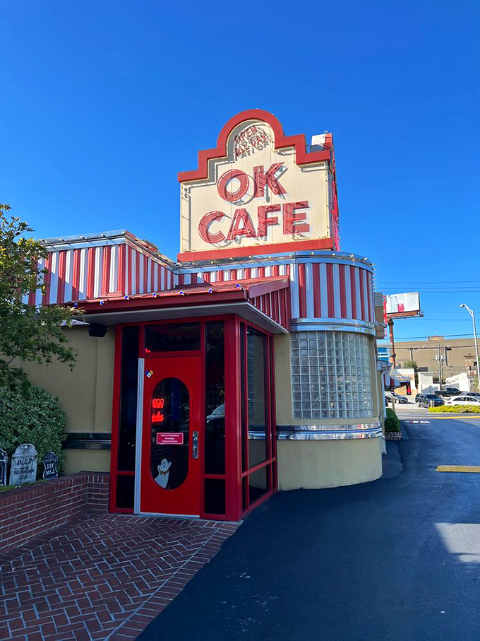 The iconic red and white striped awning of OK Cafe stands out against the Atlanta sky like a beacon for hungry souls seeking Southern comfort.