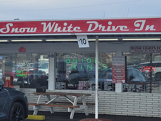 The iconic red signage of Snow White Drive In beckons hungry travelers like a culinary lighthouse in Lebanon's sea of chain restaurants.
