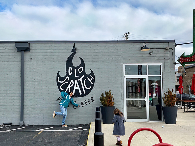 That neon arrow isn't just pointing to a restaurant&mdash;it's directing you to your new pizza obsession. Industrial chic meets culinary magic at Old Scratch's unassuming exterior.