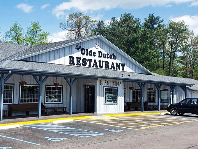 The unassuming white exterior of Olde Dutch Restaurant beckons like an old friend, promising comfort food treasures within its humble walls. 