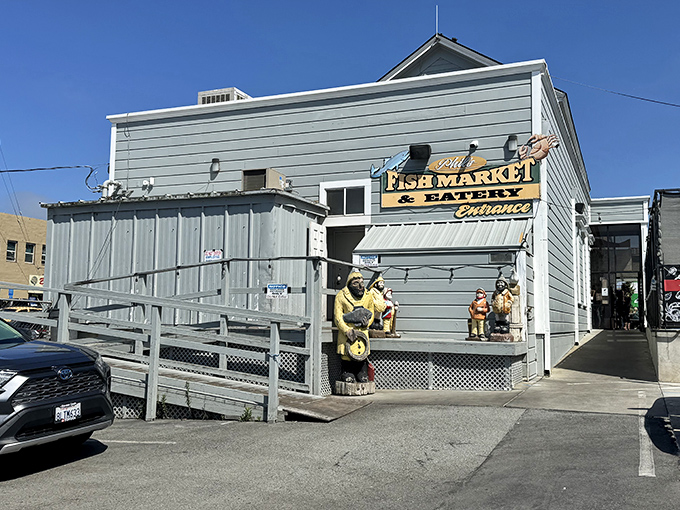 The unassuming exterior of Phil's Fish Market & Eatery stands like a seafood speakeasy – complete with nautical guardians who've seen a thousand hungry pilgrims arrive skeptical and leave converted.