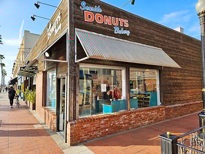The unassuming facade of Seaside Donuts Bakery hides a world of fried dough magic. That "OPEN 24HRS" sign is the bat signal for donut lovers everywhere.