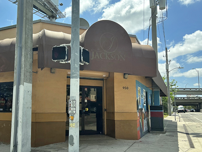 The unassuming peach-colored exterior with its burgundy awning is Miami's soul food beacon &ndash; no flash, just pure culinary promise waiting inside.