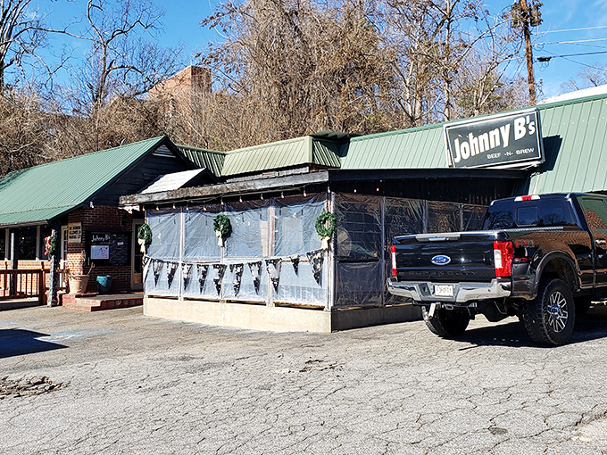 The unassuming green-roofed treasure of Dahlonega beckons with its weathered charm and plastic-enclosed patio&mdash;culinary gold hiding in plain sight.