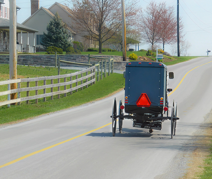The classic Amish buggy against a church backdrop isn't just transportation&mdash;it's a moving postcard of a simpler time that somehow feels right at home in 2023.