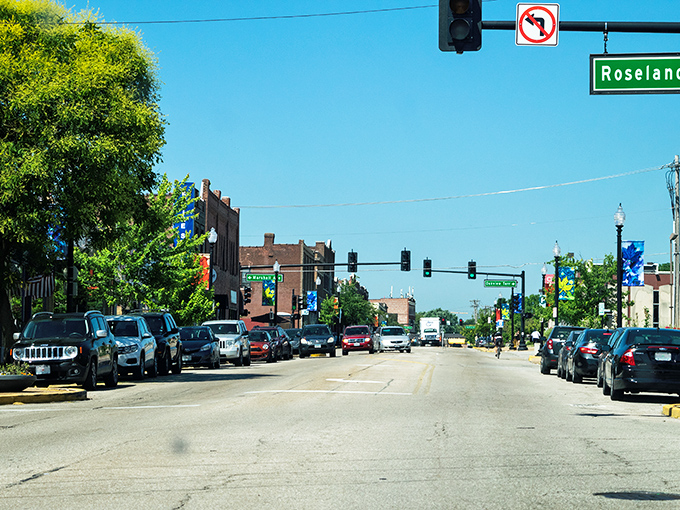 Manchester Road stretches before you like a small-town welcome mat, where brick buildings and leafy trees create that perfect "Honey, I think we could live here" moment.