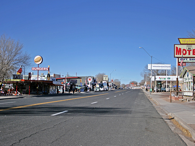 Route 66 stretches before you like a ribbon of possibilities, with Seligman's vintage storefronts standing as colorful sentinels of simpler times.