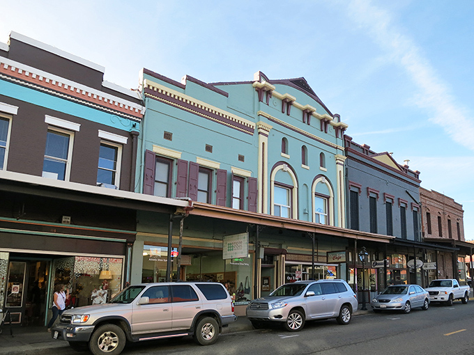 Historic buildings line Grass Valley's Main Street, their colorful facades creating a living museum where Gold Rush history and modern life dance together.