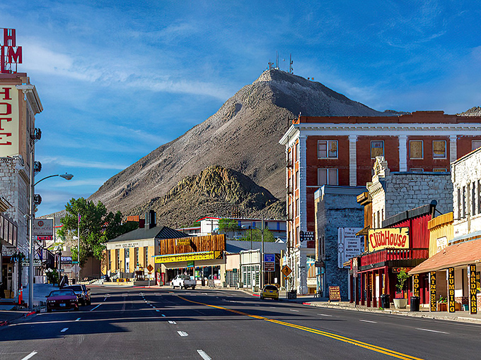 Main Street Tonopah greets visitors with historic brick buildings while fog dramatically embraces the mountain, like nature's own theater curtain rising on a mining town stage.