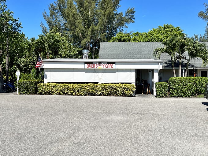 The unassuming exterior of Over Easy Cafe stands like a breakfast beacon on Sanibel Island, promising morning delights beneath the swaying palms.