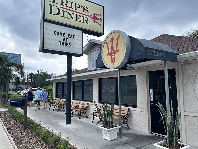 The welcoming exterior of Trip's Diner beckons hungry Tampa locals with its no-nonsense sign and cozy bench seating for the inevitable weekend wait.