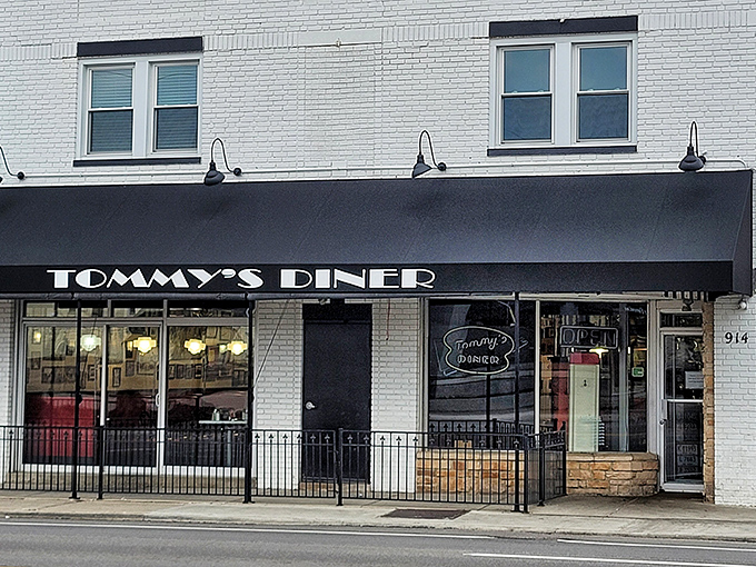Tommy's Diner stands proudly on West Broad Street, its classic black awning and white brick exterior a beacon for comfort food pilgrims across Ohio.