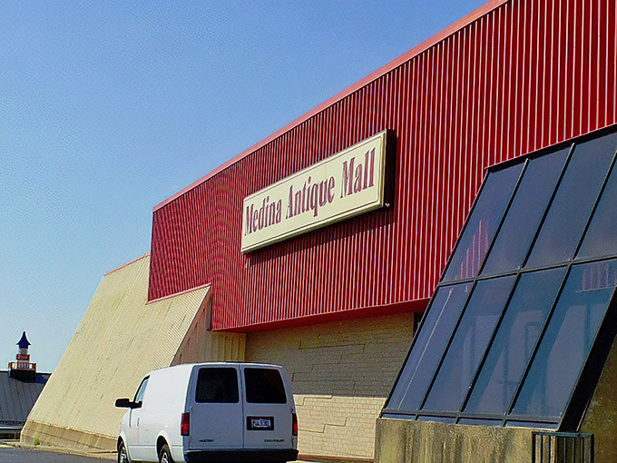 The unassuming red-trimmed exterior of Medina Antique Mall&mdash;like finding a treasure chest disguised as a regular building.