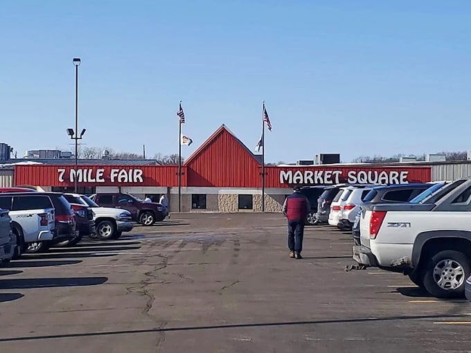 The iconic red-roofed entrance to 7 Mile Fair stands like a beacon for treasure hunters, promising adventures in bargain-hunting beneath Wisconsin skies.