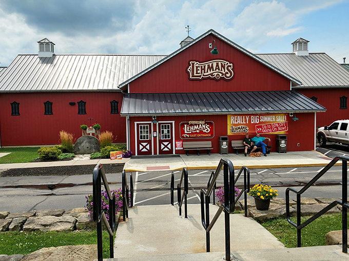 The iconic red barn exterior of Lehman's stands like a beacon of nostalgia against the Ohio sky, promising treasures that time hasn't forgotten.