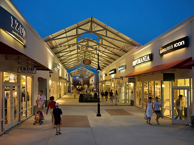 The architectural charm of Philadelphia Premium Outlets glows at twilight, with Ann Taylor's inviting storefront beckoning shoppers like a retail lighthouse in a sea of deals.