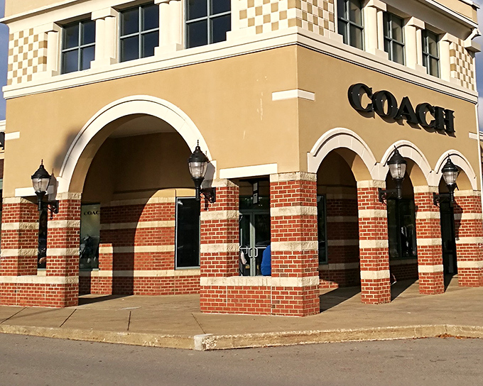 The Coach store stands like a temple to handbag devotees, its brick and cream facade promising treasures within that won't require a second mortgage.