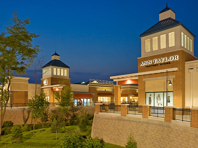 The architectural charm of Philadelphia Premium Outlets glows at twilight, with Ann Taylor's inviting storefront beckoning shoppers like a retail lighthouse in a sea of deals.