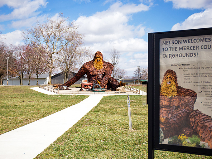 Nelson the Sasquatch lounges casually by his vintage tractor, looking like he's about to ask if you've considered switching to farm-to-table dining options.