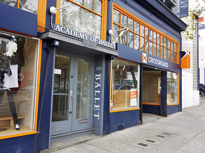 The distinctive navy blue and orange storefront of Crossroads Trading stands out like a fashion oasis on San Francisco's bustling streets.