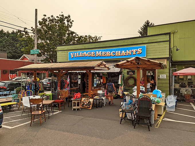 The green facade of Village Merchants beckons like a portal to treasure-hunting paradise, with sidewalk displays offering a tantalizing preview of the wonders within.