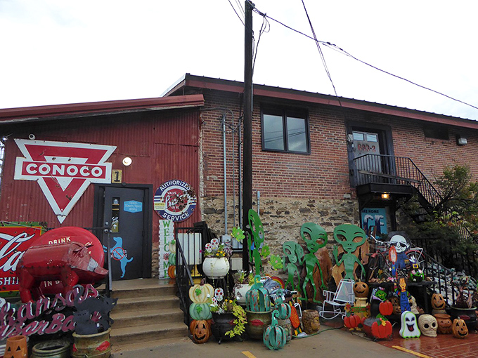 The iconic Conoco sign welcomes treasure hunters to this repurposed gas station, where seasonal decorations spill onto the porch like a festive welcome committee.