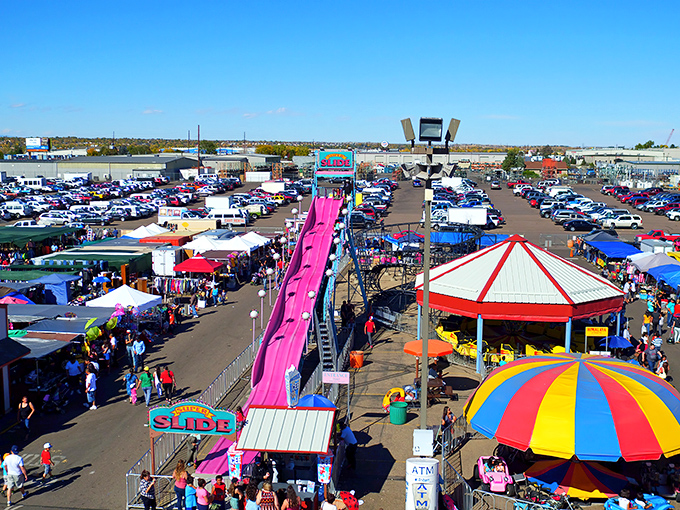 A bird's-eye view of treasure hunting paradise! The sprawling Mile High Flea Market combines carnival rides, colorful tents, and endless rows of potential discoveries under Colorado's brilliant blue sky.