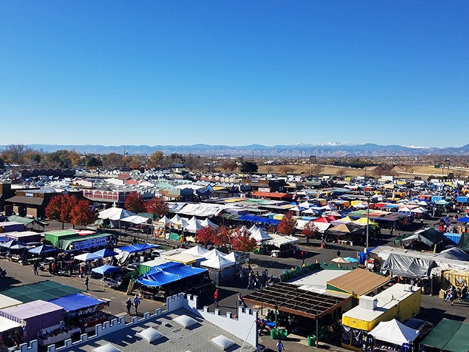 A bird's-eye view of treasure hunting paradise! The sprawling Mile High Flea Market combines carnival rides, colorful tents, and endless rows of potential discoveries under Colorado's brilliant blue sky.