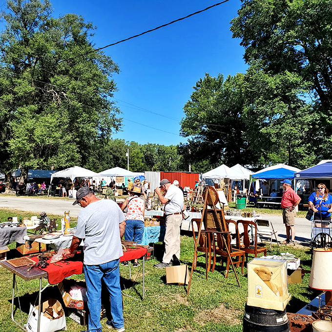 An aerial view reveals Sparks Flea Market's true scale—a sprawling treasure hunter's paradise nestled among Kansas farmland, where parking lots fill with hopeful bargain seekers.