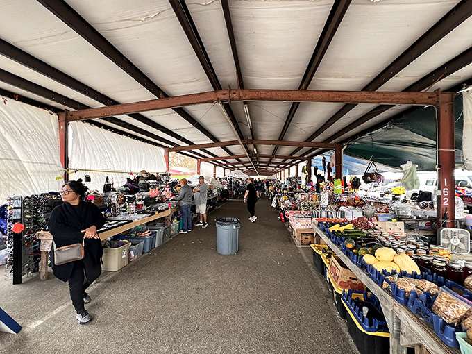 The red "FLEA MARKET" sign beckons like a siren call to bargain hunters. Treasure awaits under this bustling pavilion in Pass Christian.