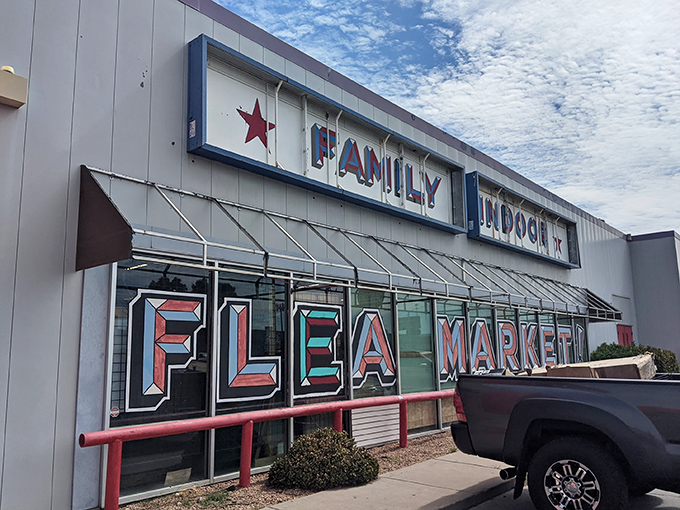 The red and white fa&ccedil;ade of Family Indoor Flea Market stands like a beacon for treasure hunters. Bargain paradise awaits behind those doors!
