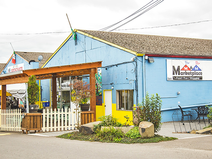 The vibrant blue exterior of M&M Marketplace stands out like a beacon of bargain-hunting hope, complete with cheerful yellow accents that promise colorful discoveries inside.