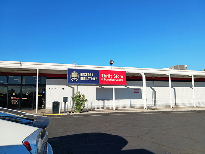 The unassuming exterior hides a bargain hunter's paradise. Those colorful pennant flags are basically saying "Treasures ahead!" in thrift-speak.