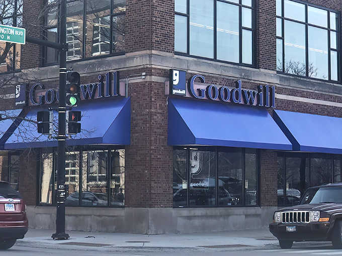 The iconic blue awnings of Goodwill beckon like a retail oasis in Chicago's urban landscape, promising treasures within those brick walls.