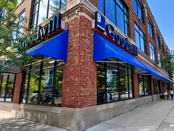 The iconic blue awnings of Goodwill beckon like a retail oasis in Chicago's urban landscape, promising treasures within those brick walls.